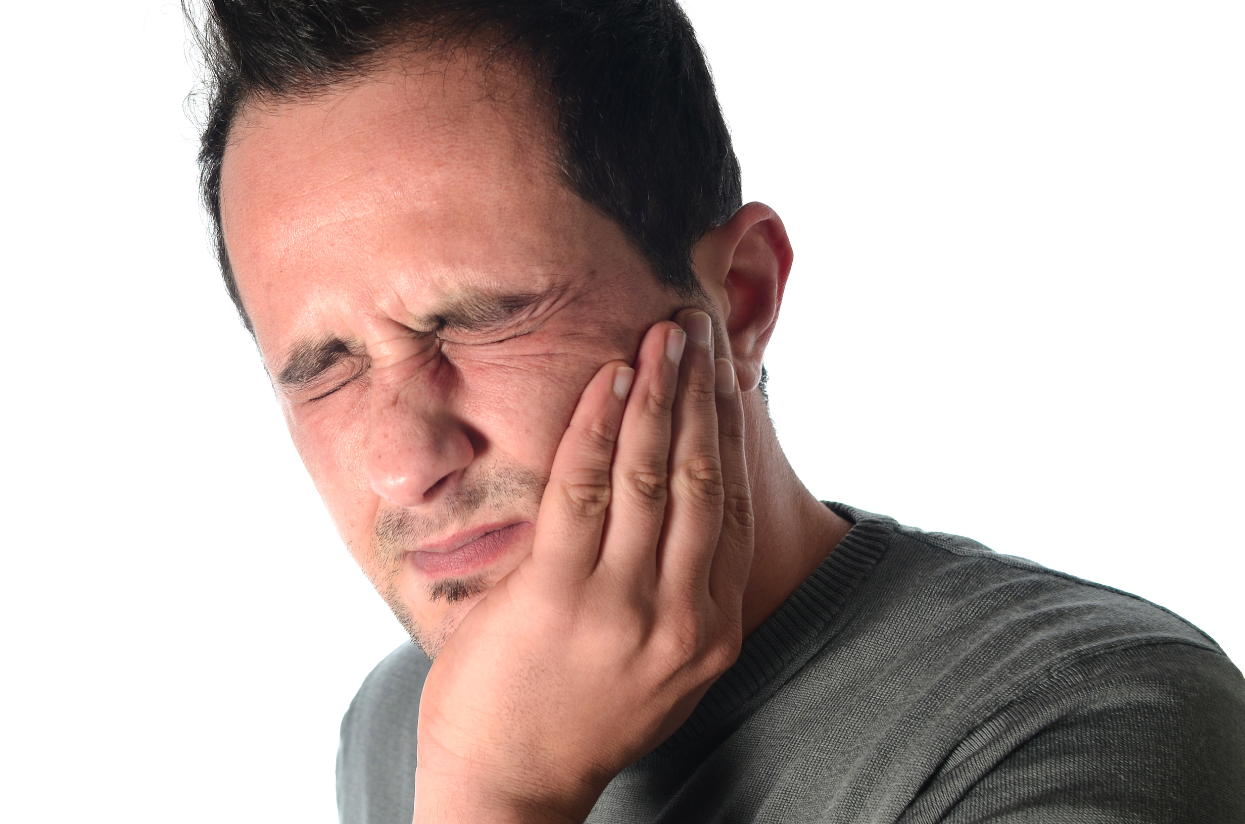 man holding cheek in pain - Lifetime Dental Blog